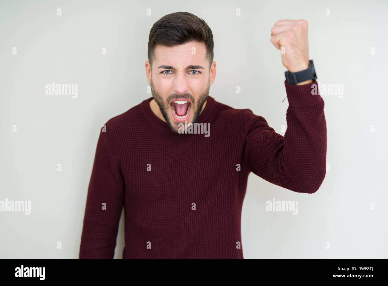 Young handsome man wearing a sweater over isolated background angry and ...