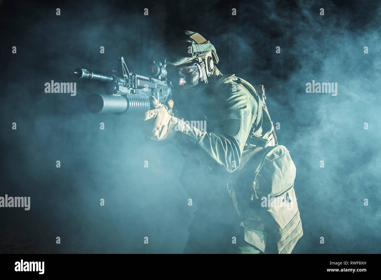Backlit photo of a soldier moving amonst the smoke during a battle ...