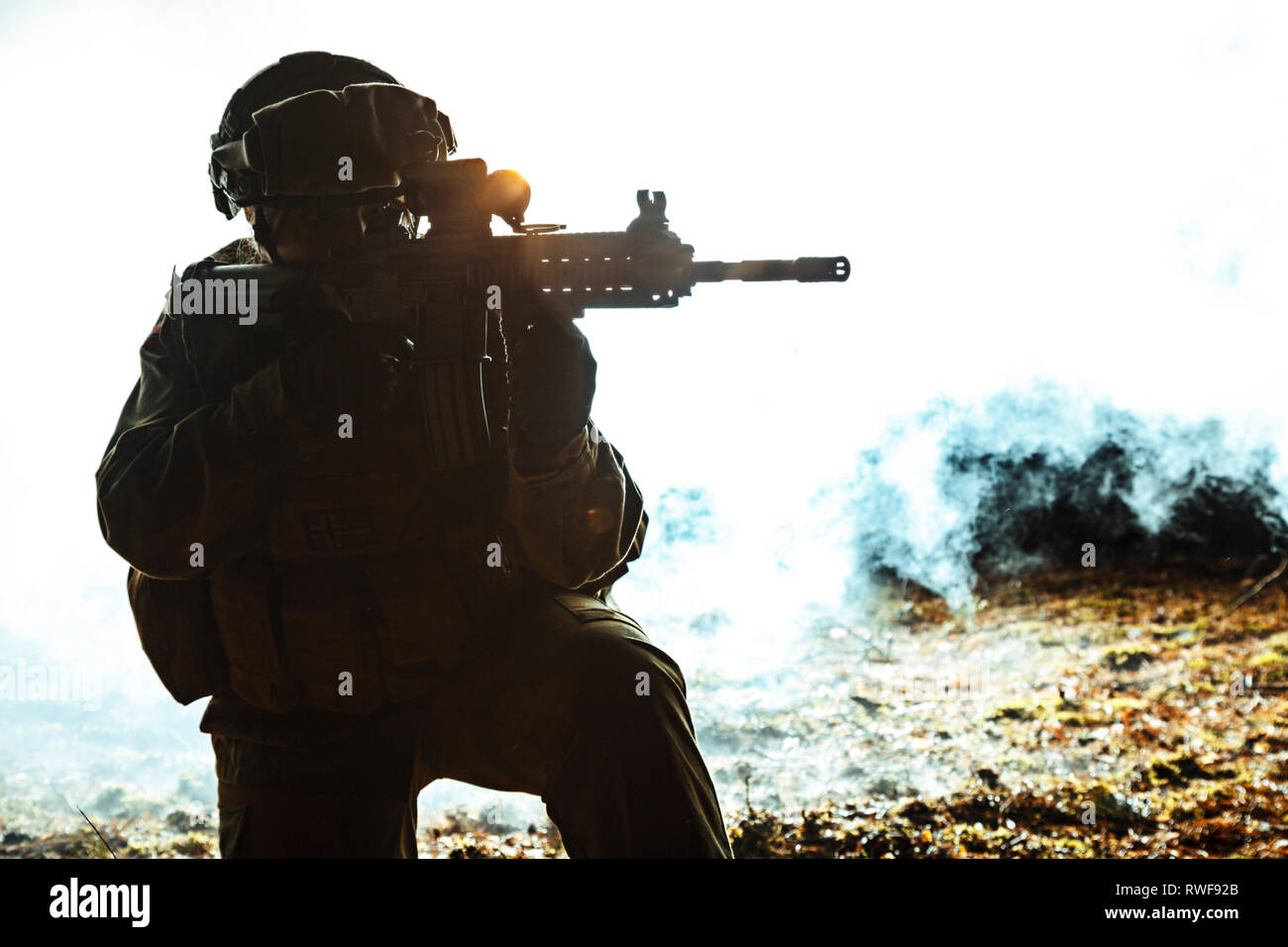 Black silhouette of soldier in the smoke during a battle operation ...