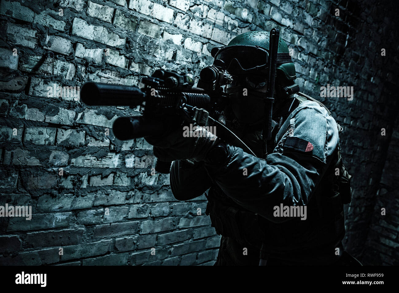 Special forces operator pointing weapon in the dark Stock Photo - Alamy