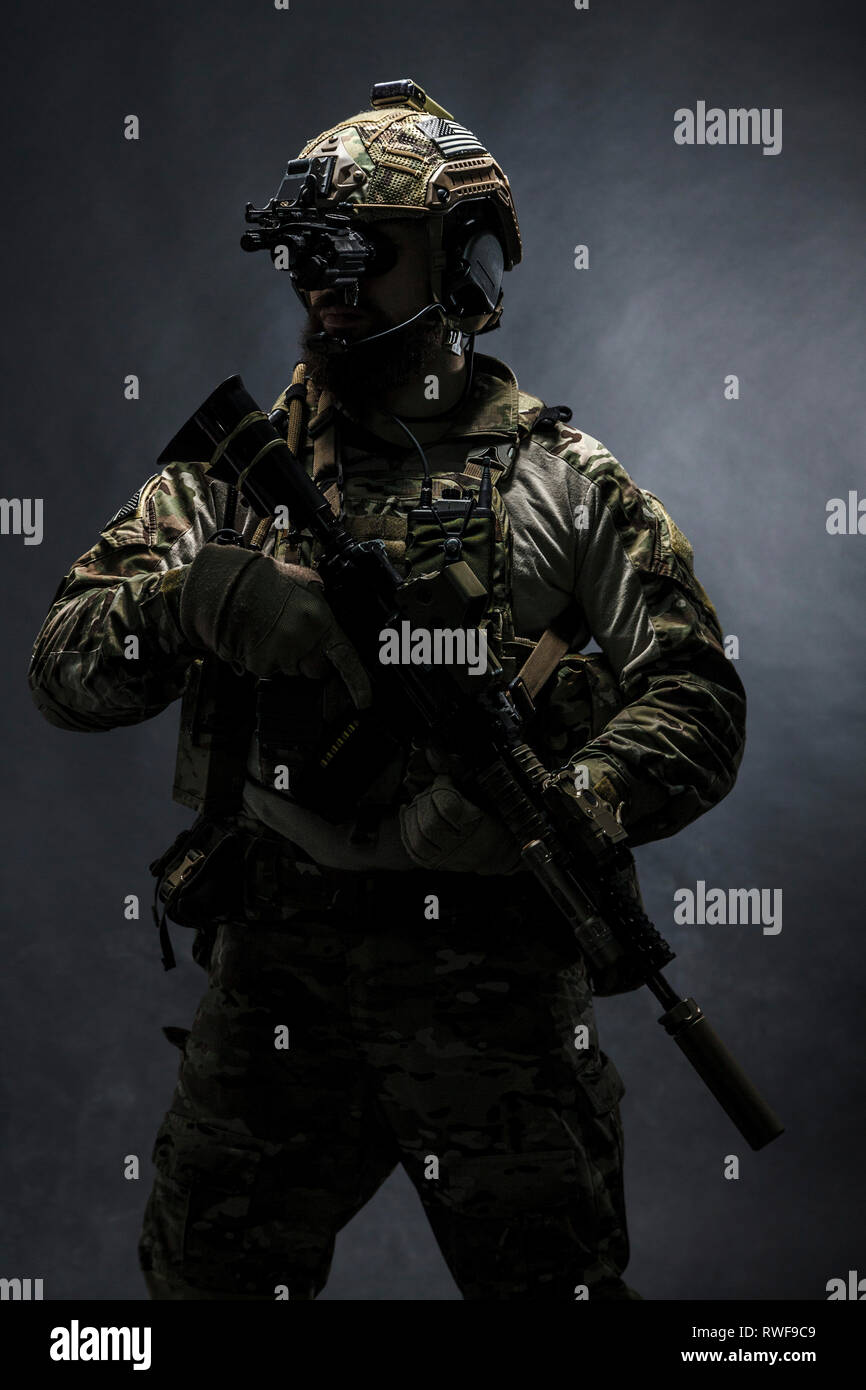 Bearded soldier in combat uniform with weapon, studio shot Stock Photo ...