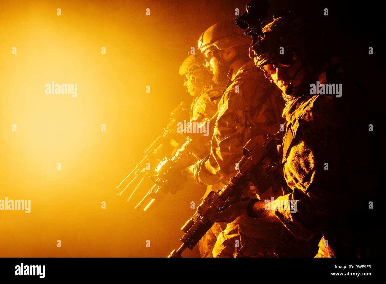 Group of security forces in combat uniforms with rifles, lined in the ...