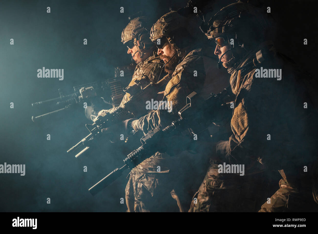 Group of security forces in combat uniforms with rifles, lined in the ...