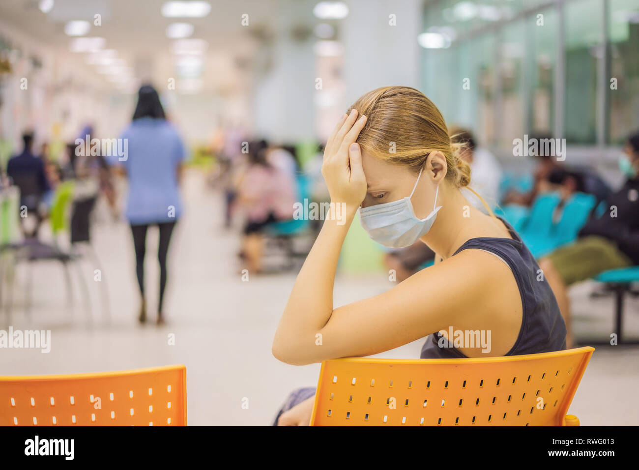 Young woman sitting in hospital waiting for a doctor's appointment ...