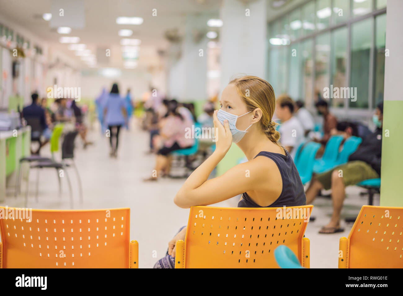 Young Woman Sitting In Hospital Waiting For A Doctors Appointment Patients In Doctors Waiting