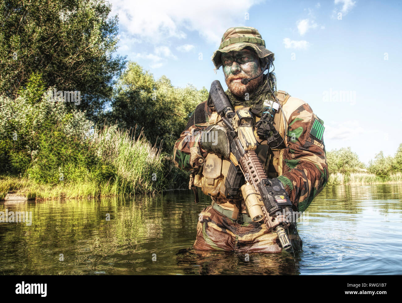 Bearded soldier of special forces in action during a river raid in the ...