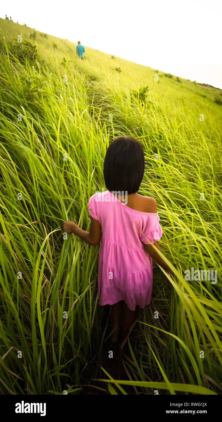 Young Filipino girl hiking grassy trail with tour group - Palumbanes ...