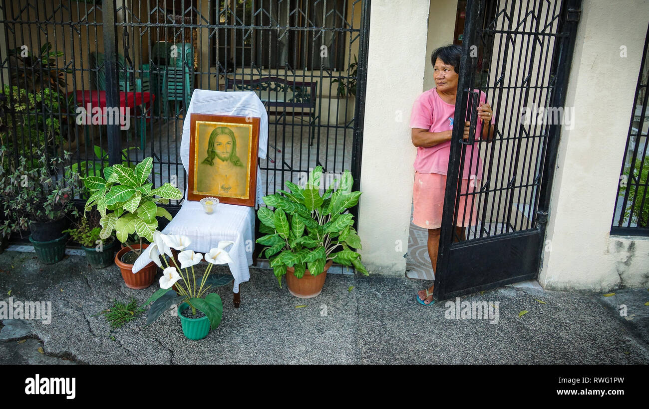 Woman at House Gate During Christ the King Procession - Miagao, Iloilo ...
