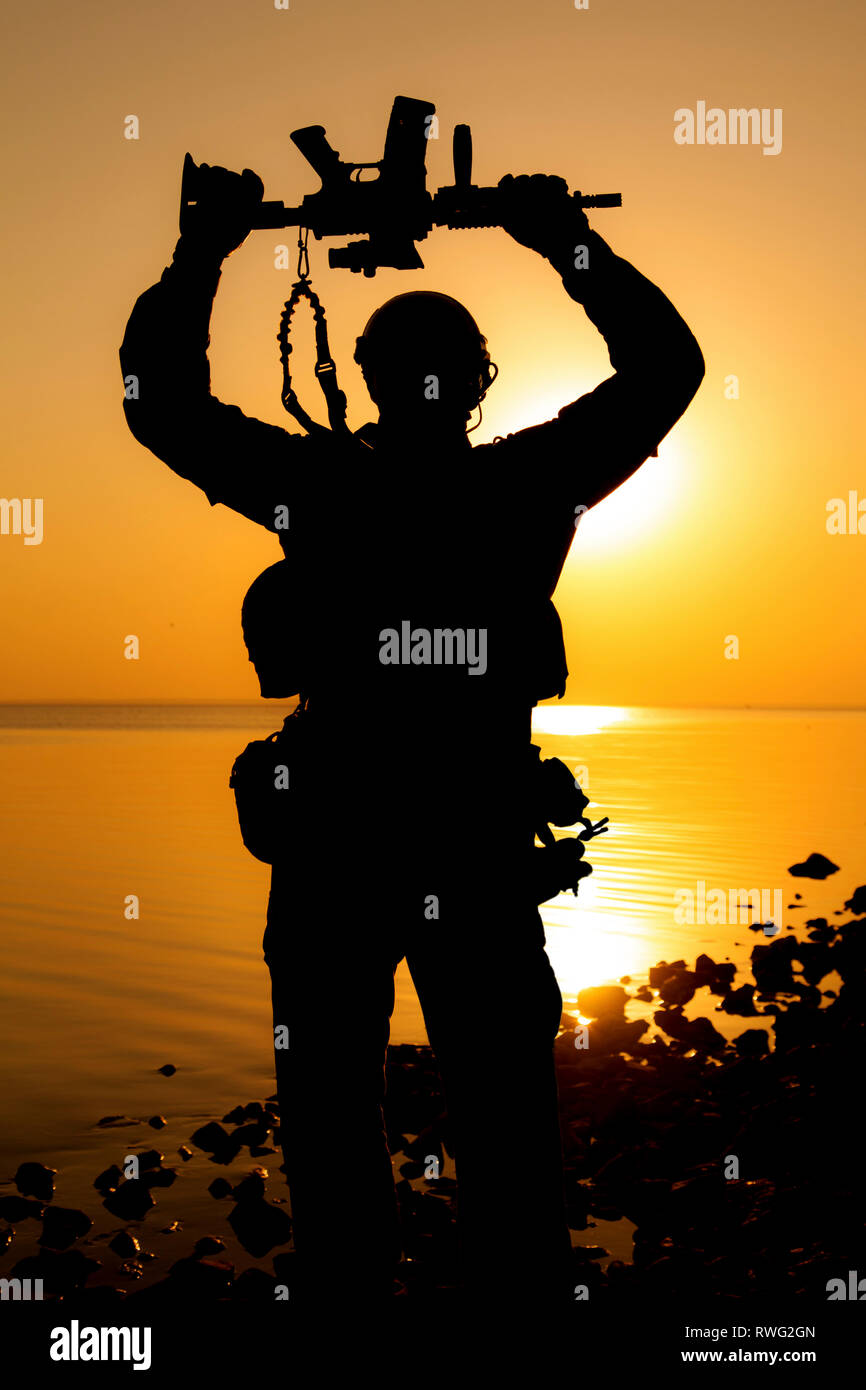 Soldier holding gun rifle hi-res stock photography and images - Alamy