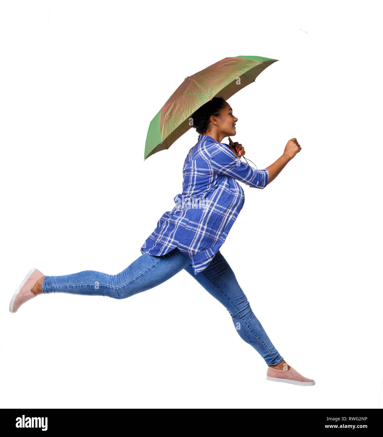 Side view of a woman balancing with an umbrella. girl jumps over a ...
