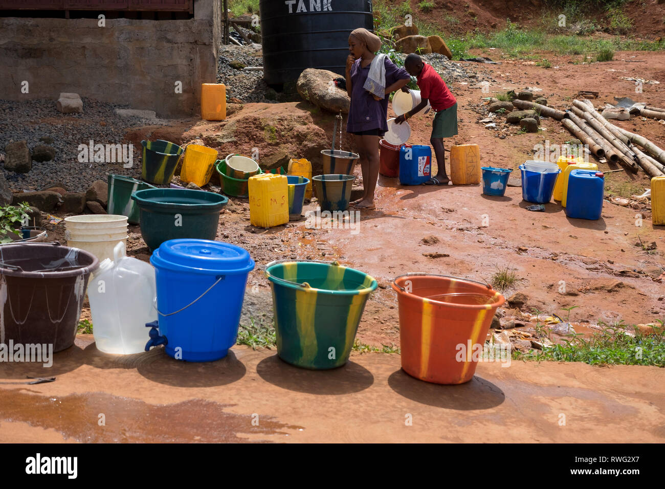 Kroo Bay, one of the worst slums in Freetown, Sierra Leone. Lining up ...
