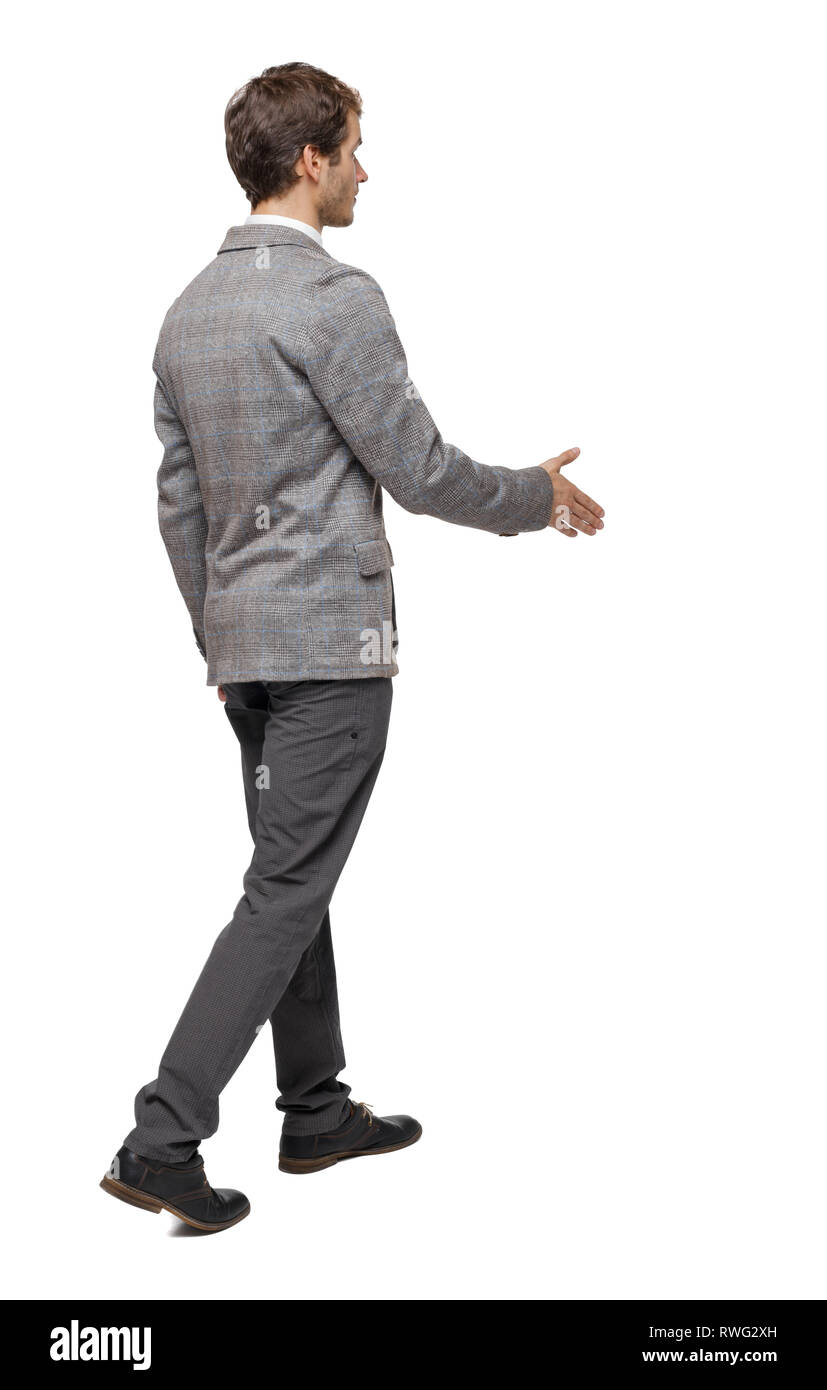 Back view of a walking businessman who stretches his hand for a ...