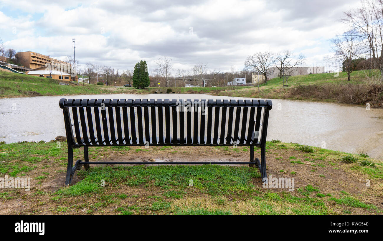Park bench overlooking flooded creek Stock Photo - Alamy