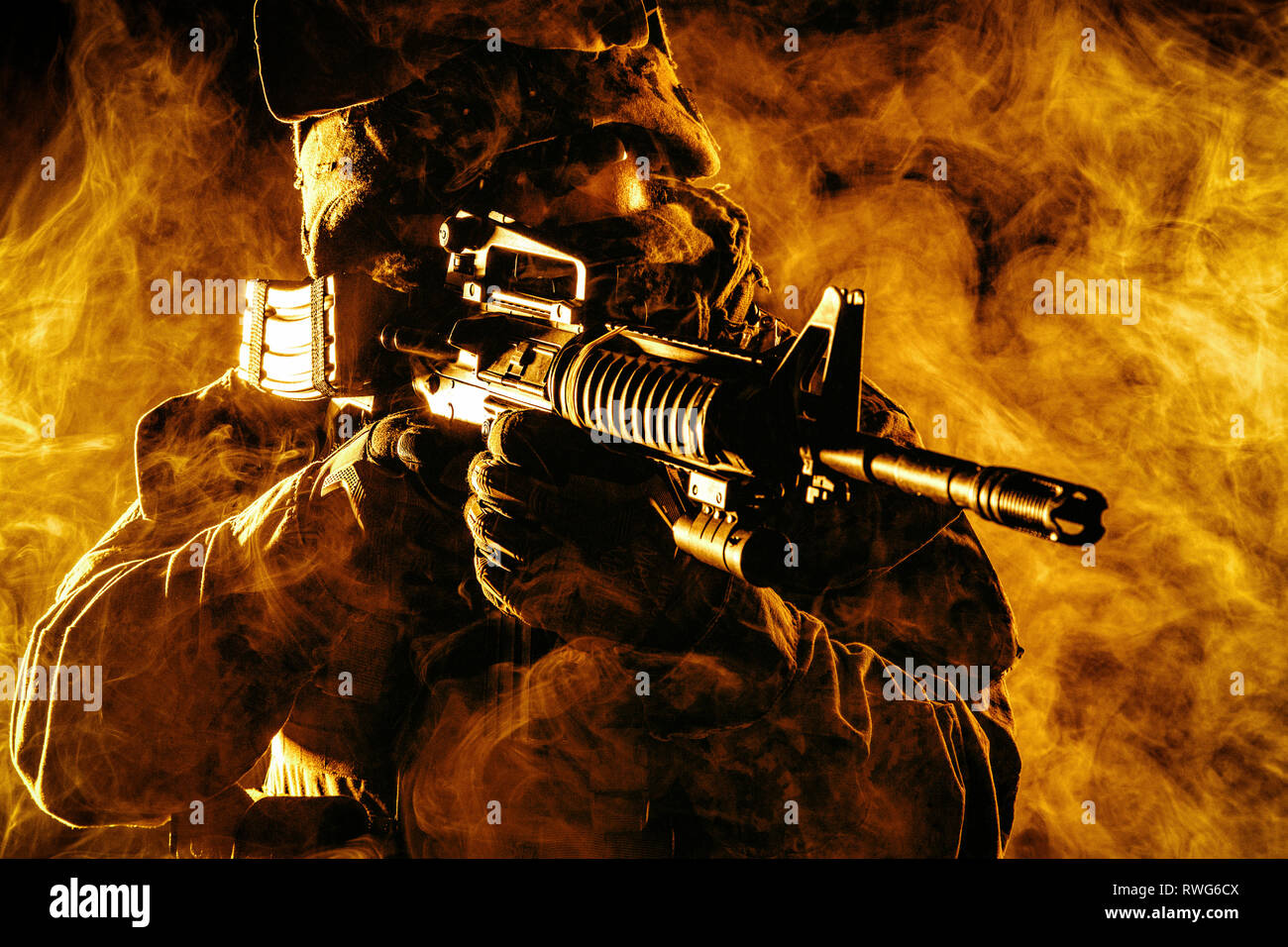 Studio shot of U.S. Marine pointing rifle, surrounded by smoke Stock ...