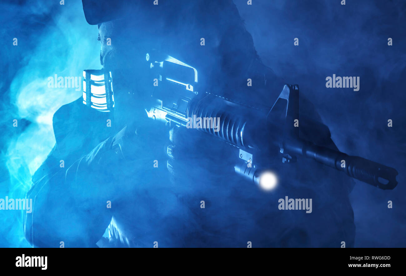 Studio shot of U.S. Marine pointing rifle, surrounded by smoke Stock ...