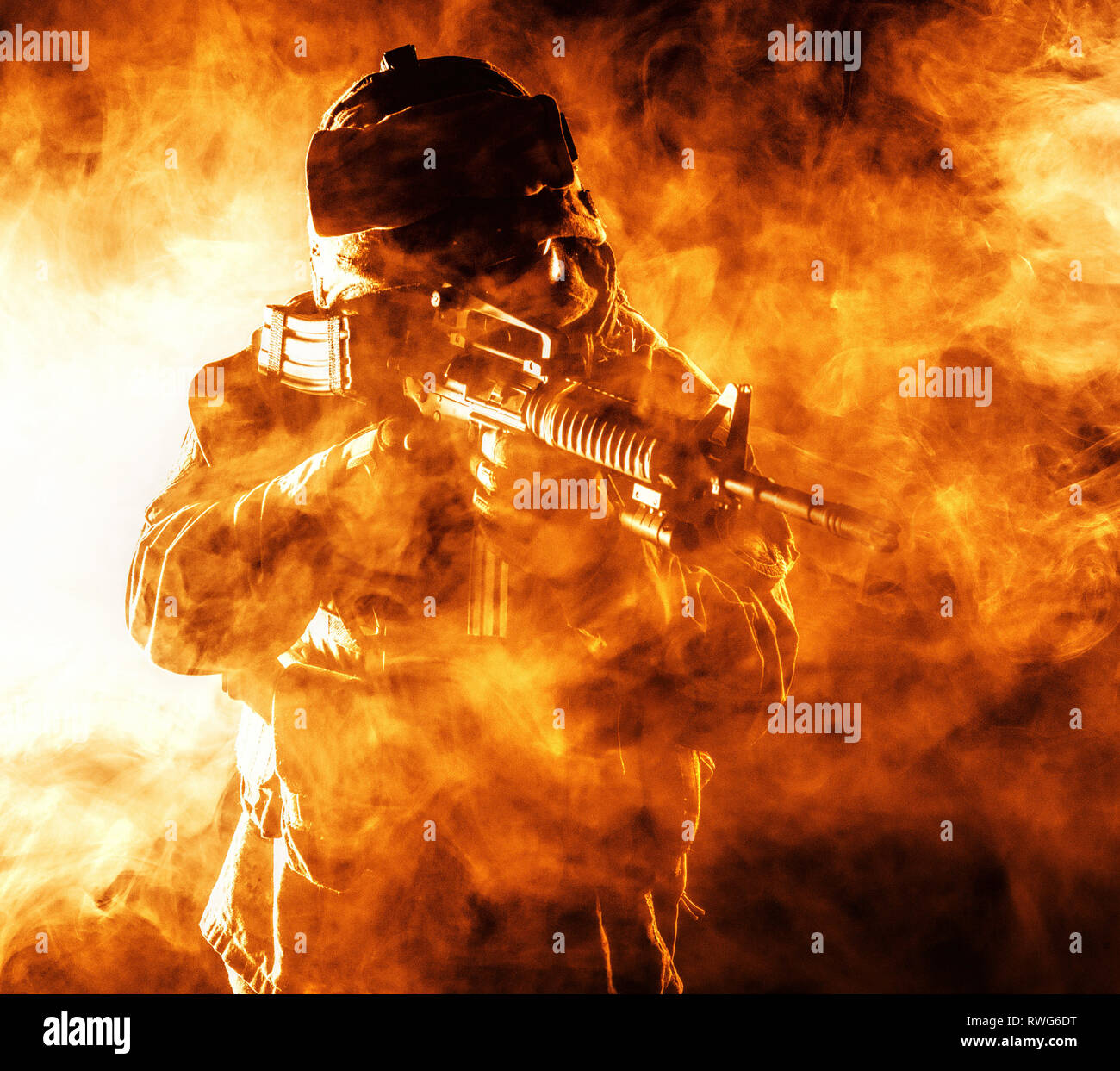 Studio shot of U.S. Marine pointing rifle, surrounded by smoke Stock ...