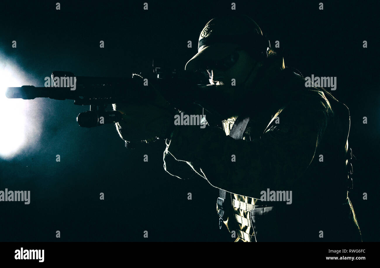Studio shot of U.S. Marine pointing rifle, surrounded by smoke Stock ...