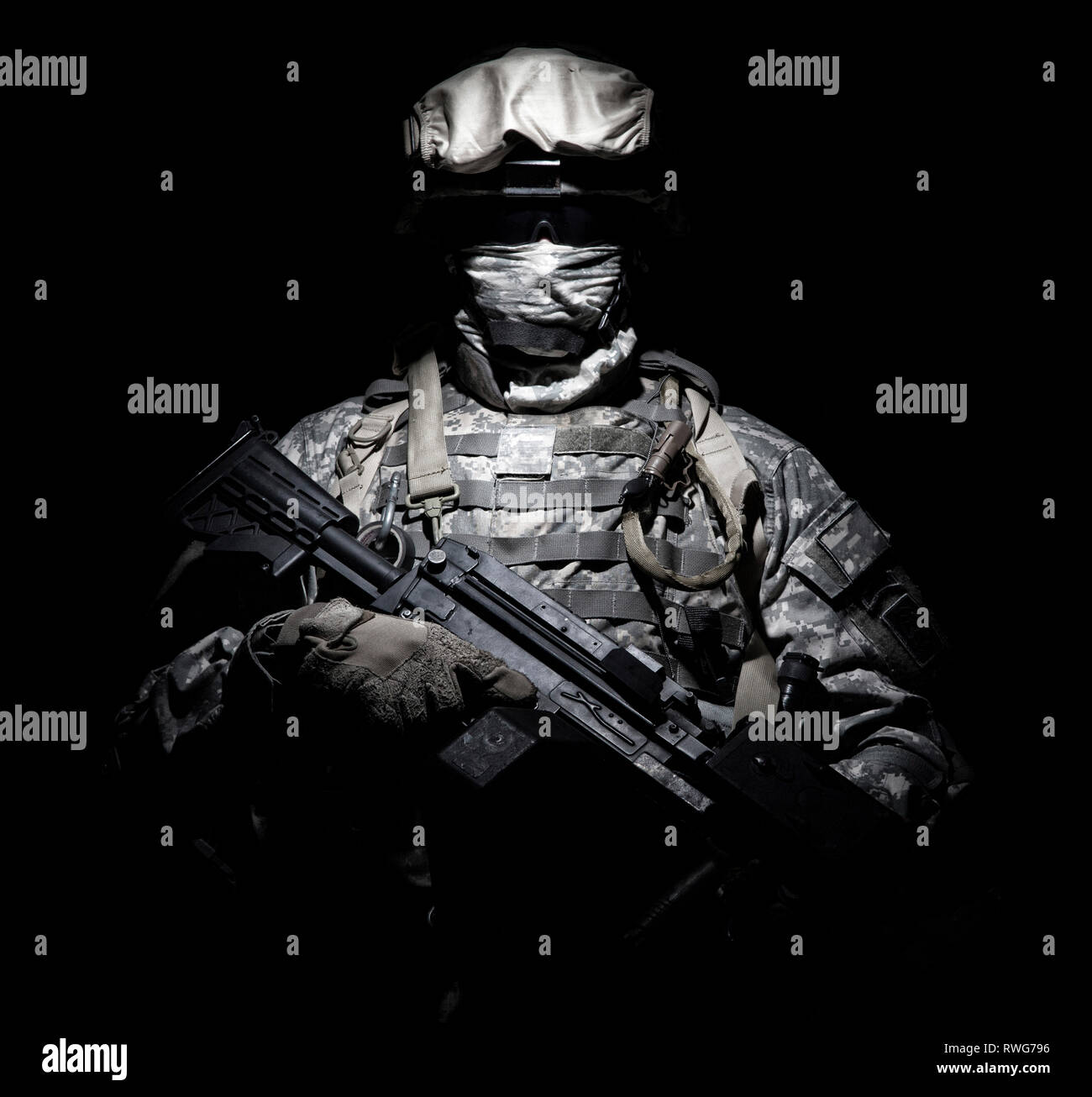 U.S. Armed forces soldier wearing a mask, armed with a machine gun ...