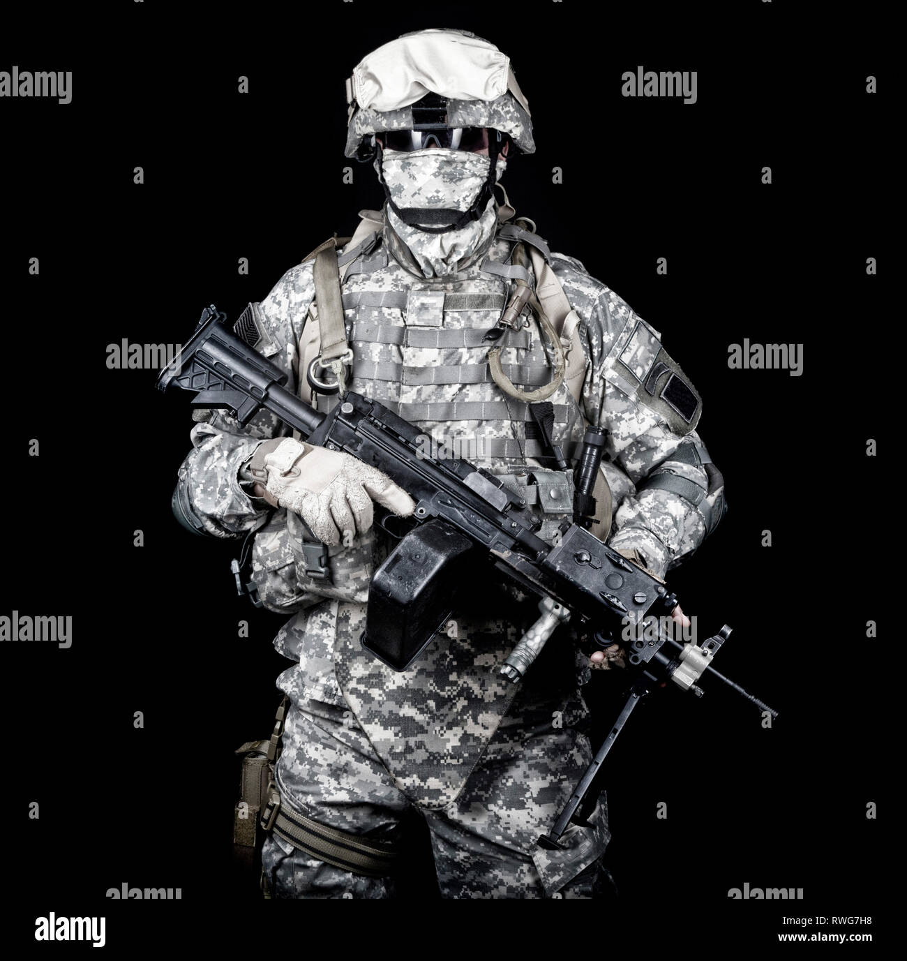 U.S. Marine in digital camouflage combat uniform, holding a light ...