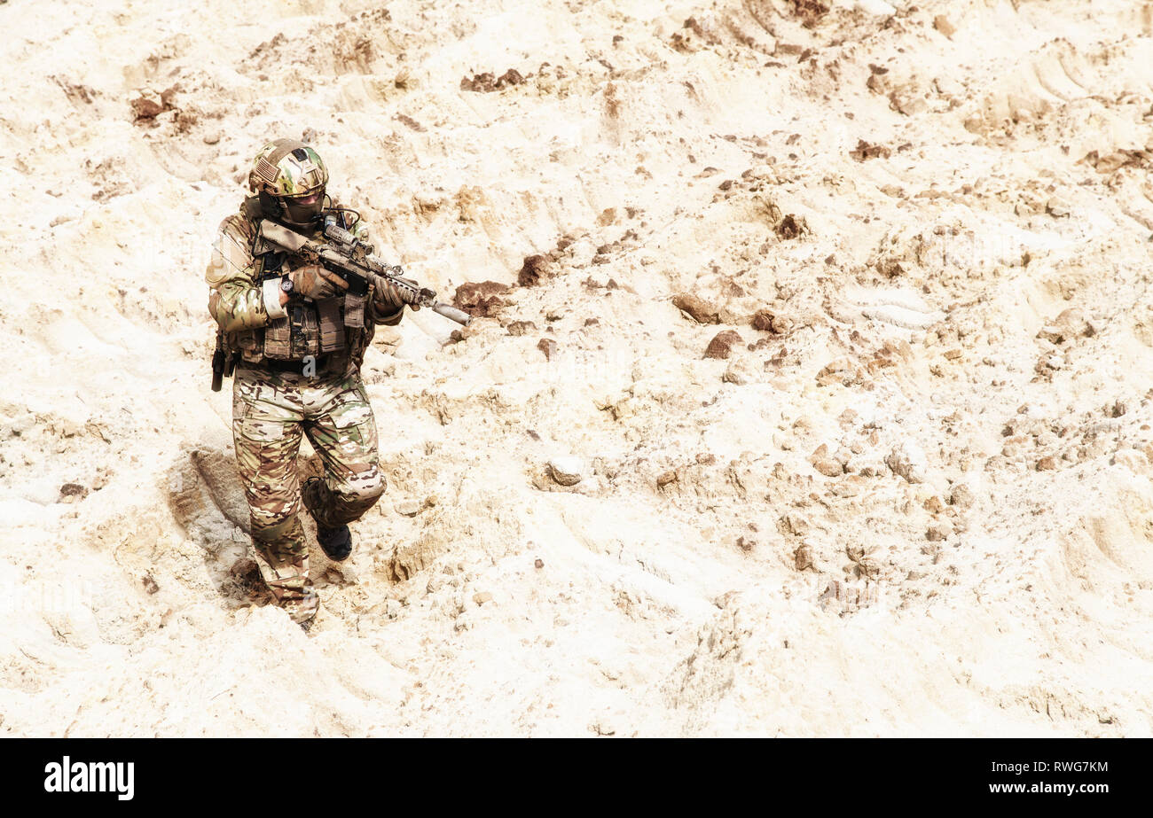 U.S. commando carrying out a mission in a desert area of the Middle ...