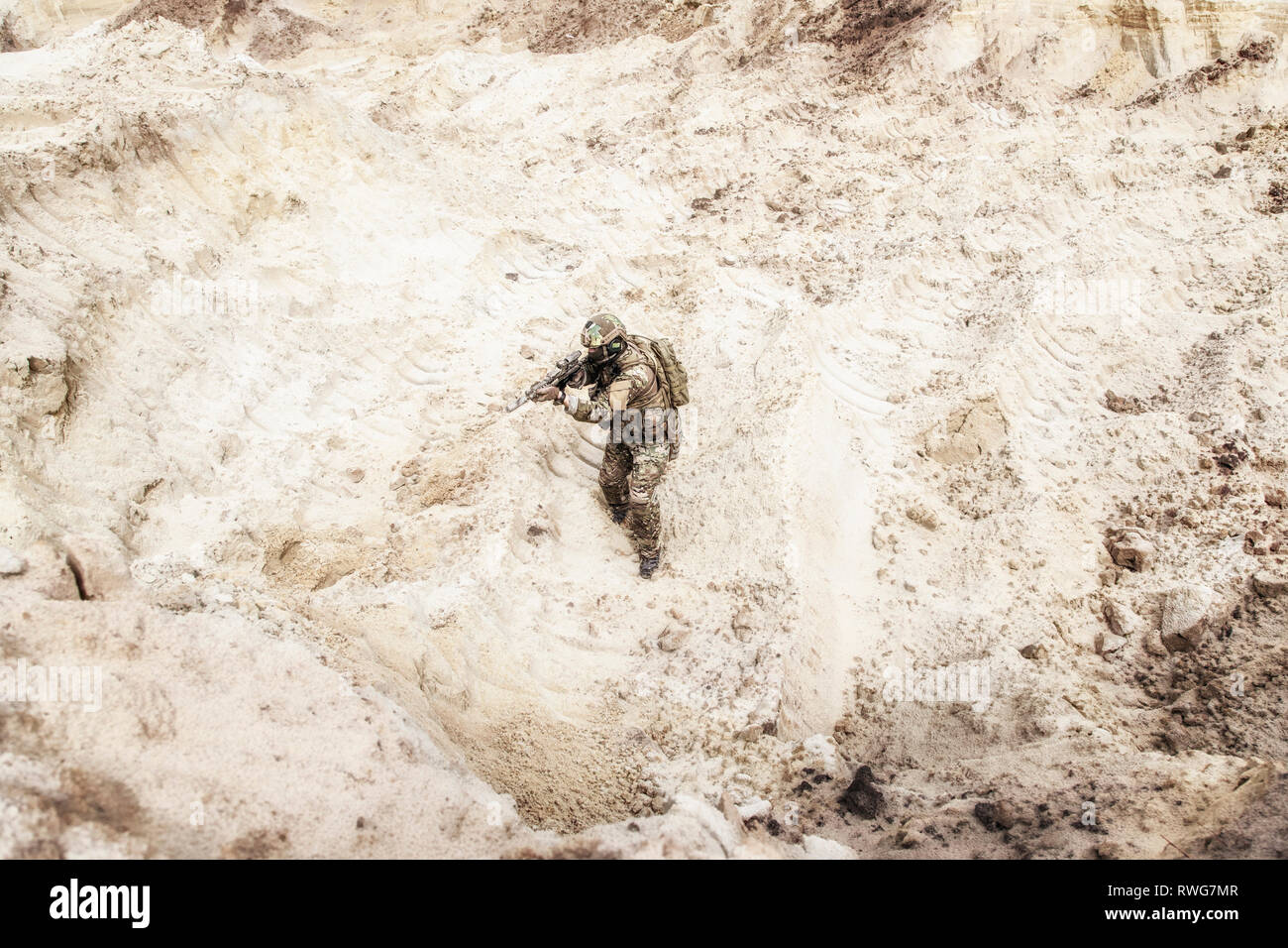 U.S. commando carrying out a mission in a desert area of the Middle ...