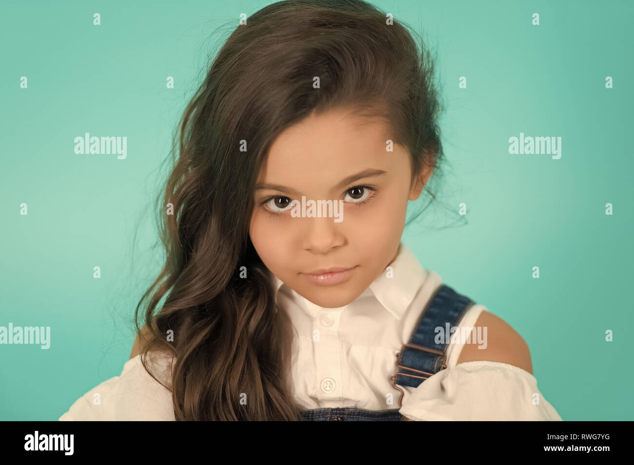 Little modern model in studio. Curly hairstyle, fashion clothes Stock ...
