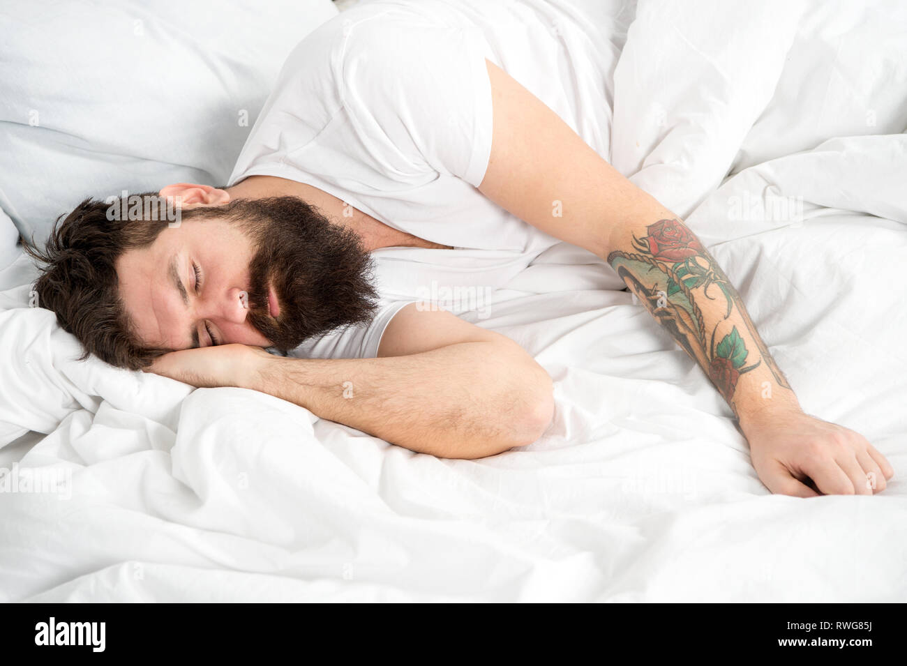 Lazy morning. Man bearded hipster sleepy in bed. Early morning hours ...