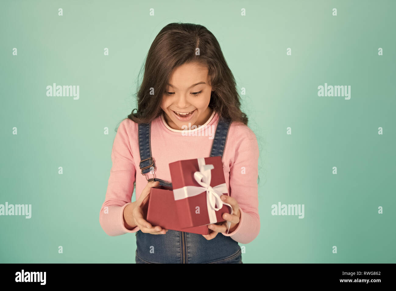 What a surprise. Child surprised excited holds gift box turquoise ...
