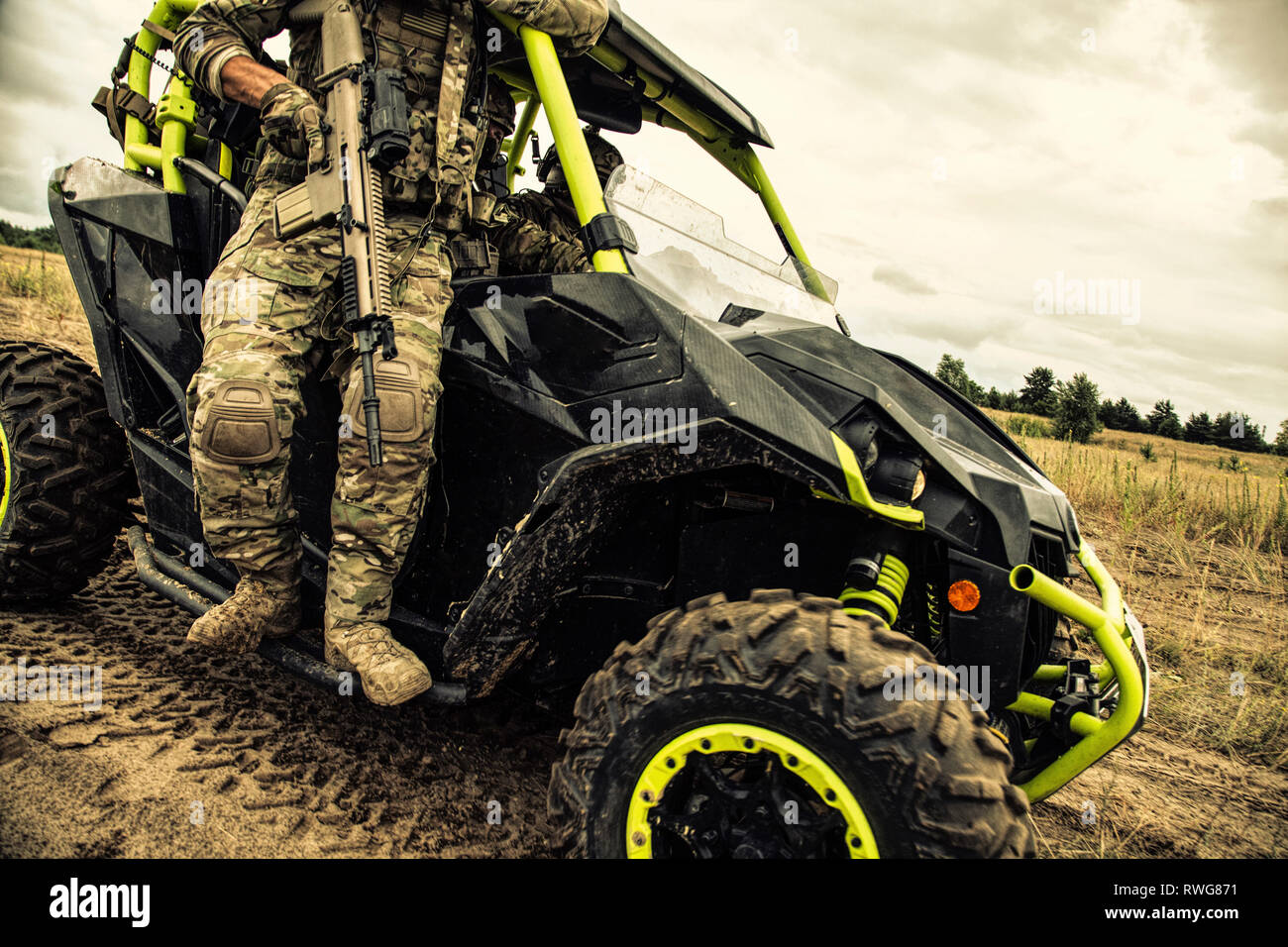 Commandos team driving an off-road vehicle under on the battlefield ...