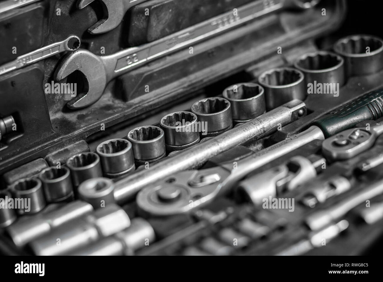 Flat Lay metal tools: wrenches, ratchet, a set of interchangeable heads ...