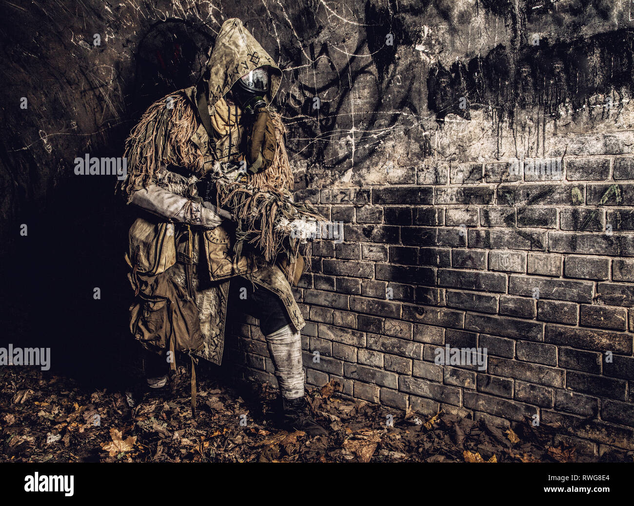 Post apocalyptic creature dressed in rags and gas mask, hiding in ...
