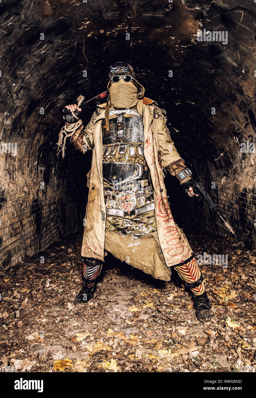 Post apocalyptic survivor holding a pistol and machete in an abandoned ...