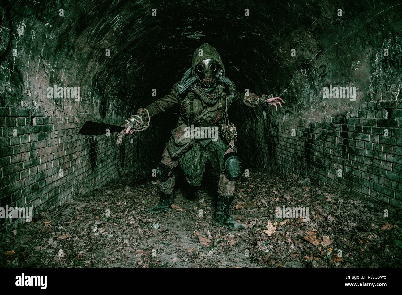 Mutant creature in tatters and gas mask jumps out of the darkness in an ...