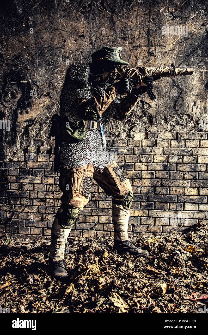 Post apocalyptic soldier with handmade gun and body armor in an ...