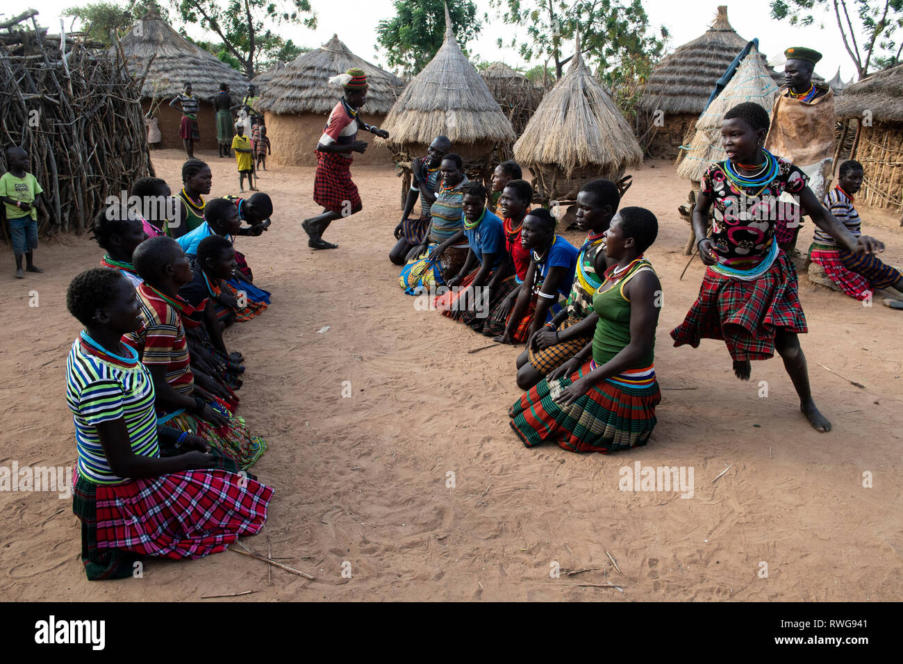 Traditional game playing in a Karamojong village, northern Uganda Stock ...