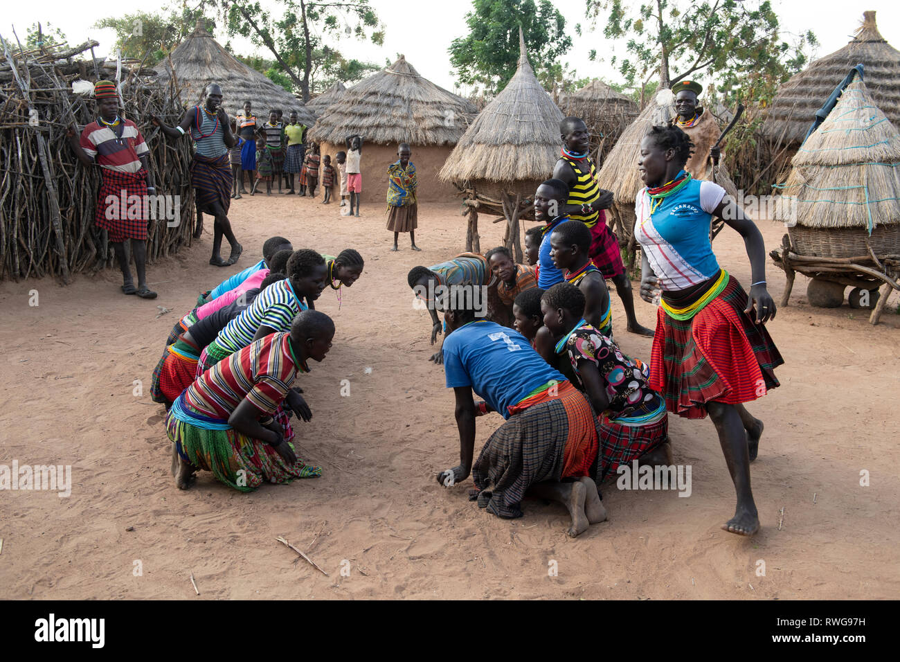Traditional game playing in a Karamojong village, northern Uganda Stock ...