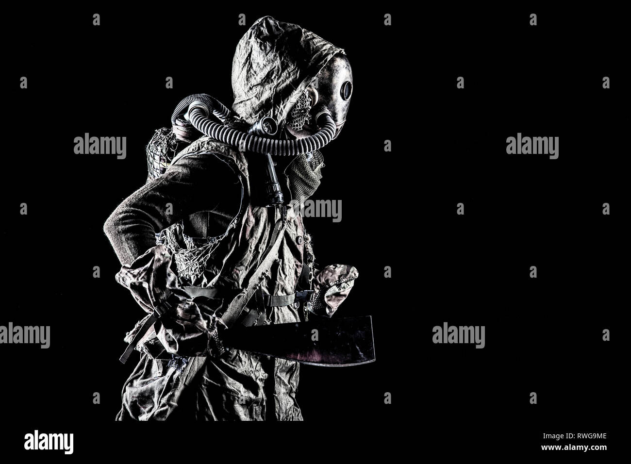 Post apocalyptic creature in ragged clothes and gas mask, armed with a ...