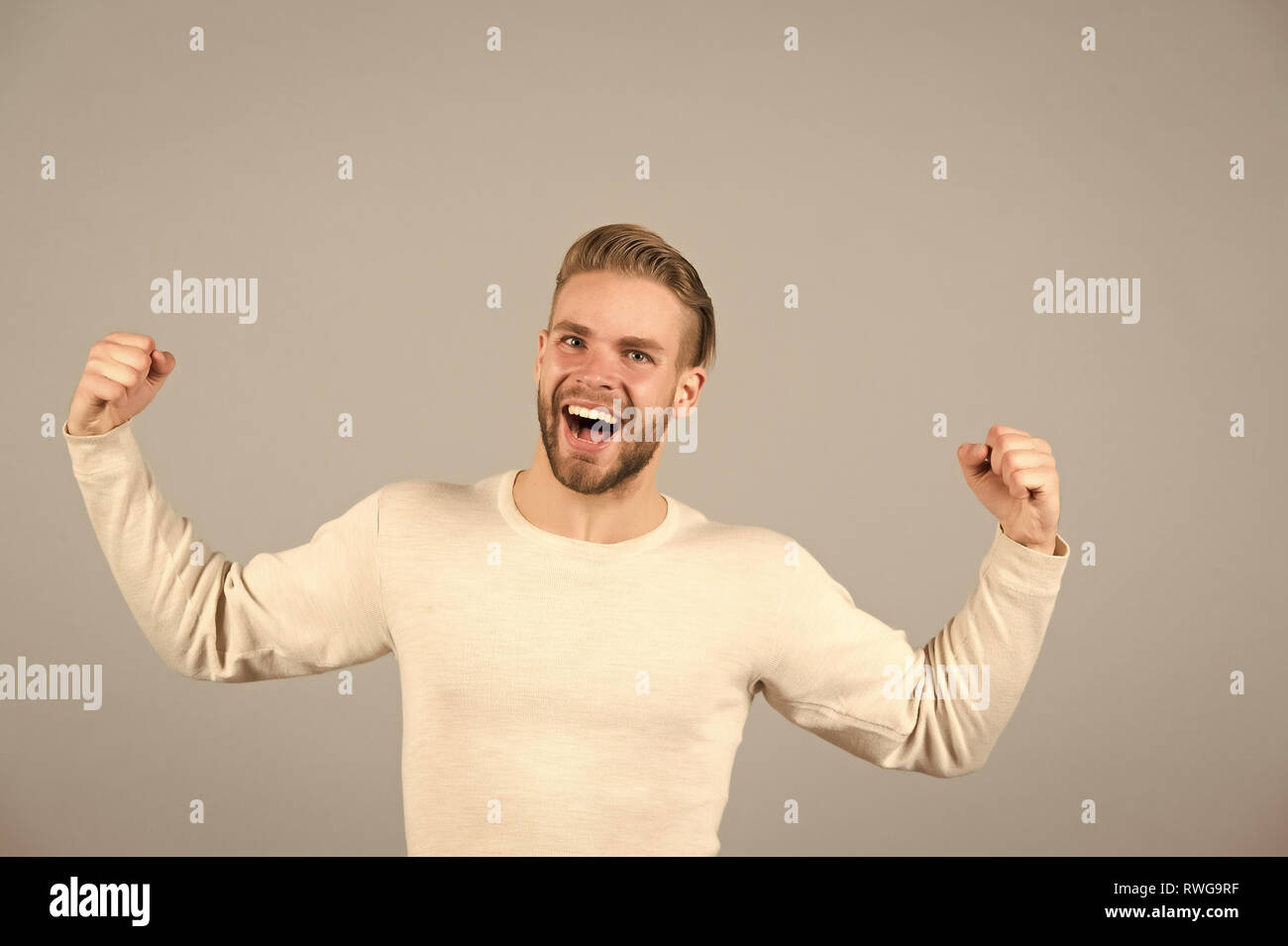 Cheerful winner. Man happy cheerful face posing with muscles as winner ...