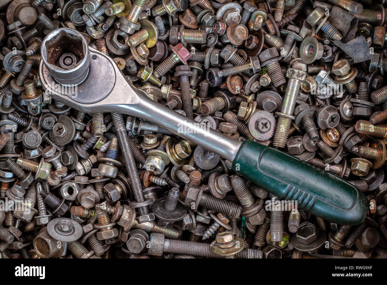 Flat Lay metal ratchet lie on the background of various metal cogs ...