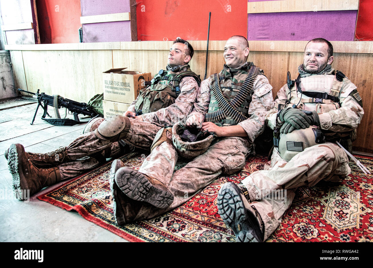 U.S. Marines talking and resting while sitting on the floor at their ...