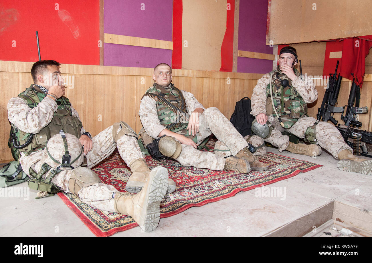 U.S. Marines talking and resting while sitting on the floor at their ...