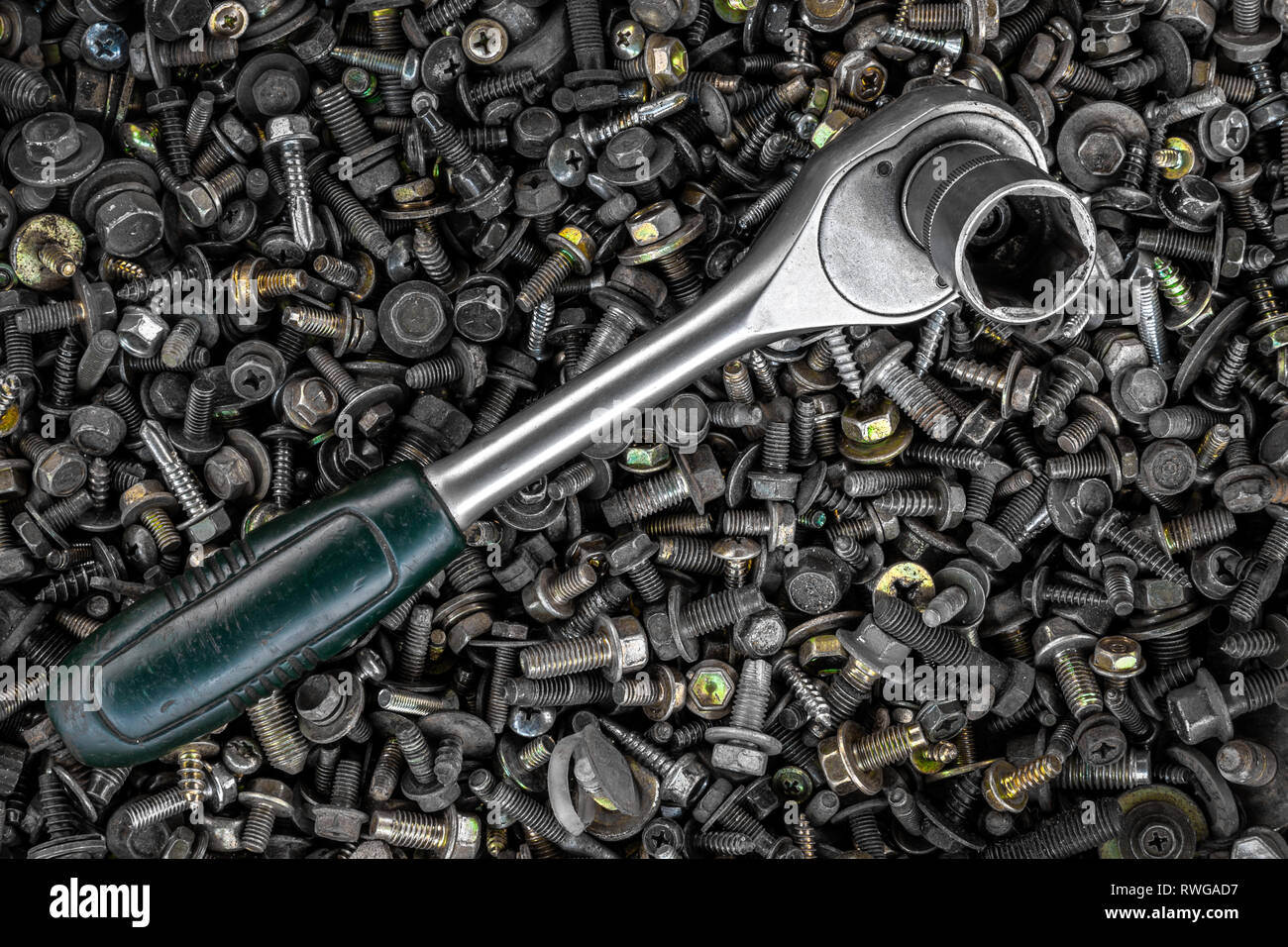 Flat Lay metal ratchet lie on the background of various metal cogs ...