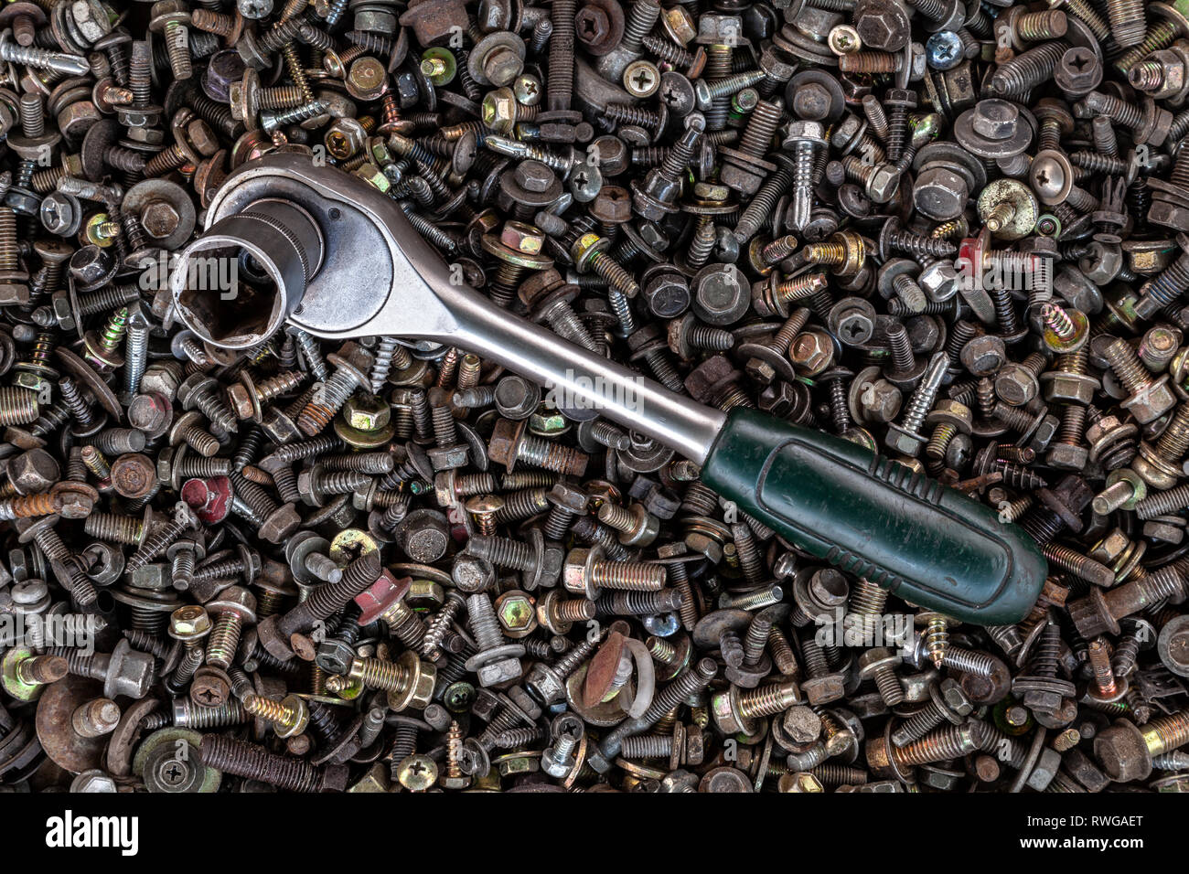 Flat Lay metal ratchet lie on the background of various metal cogs ...