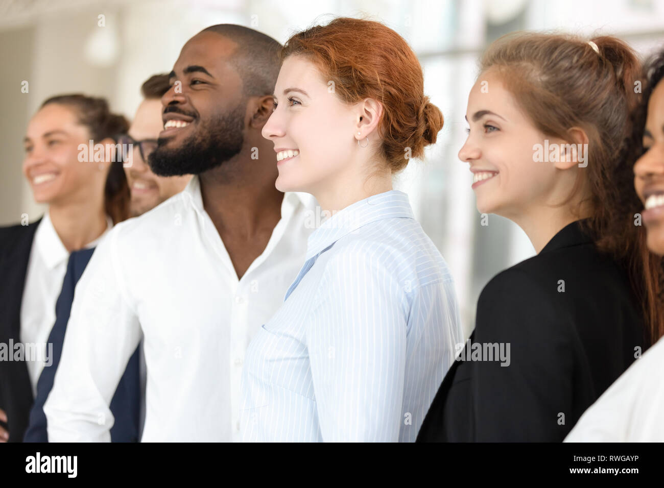 Team of smiling diverse office workers posing for photo indoors Stock ...