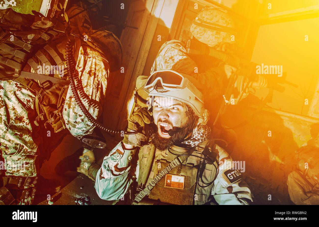 Commando team leader screaming in radio handset during an intensive ...