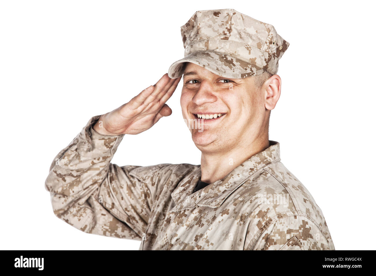 Shoulder studio portrait of a smiling U.S. soldier giving hand salute ...