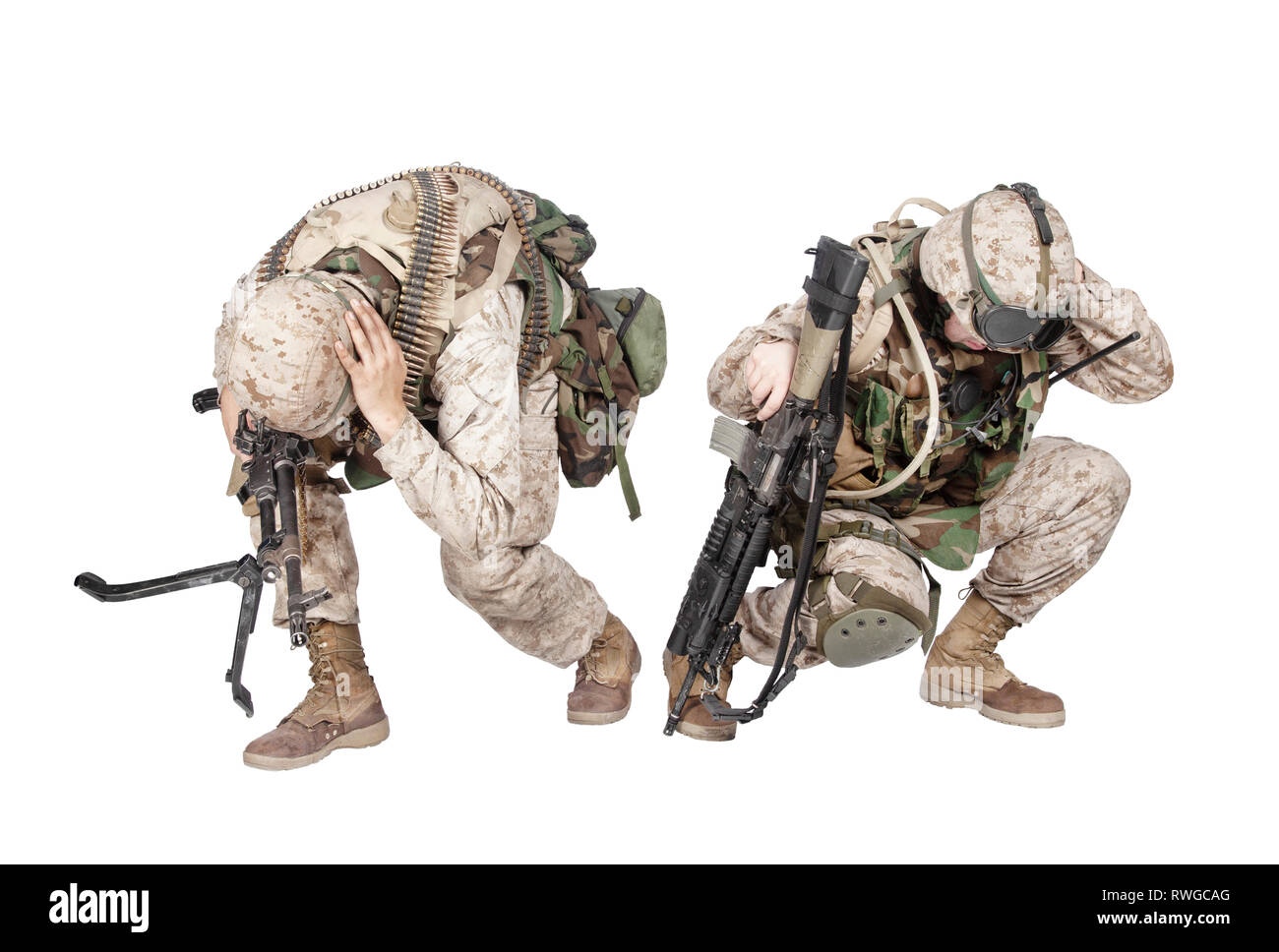 Two soldiers crouching to the ground covering their ears after a fire ...