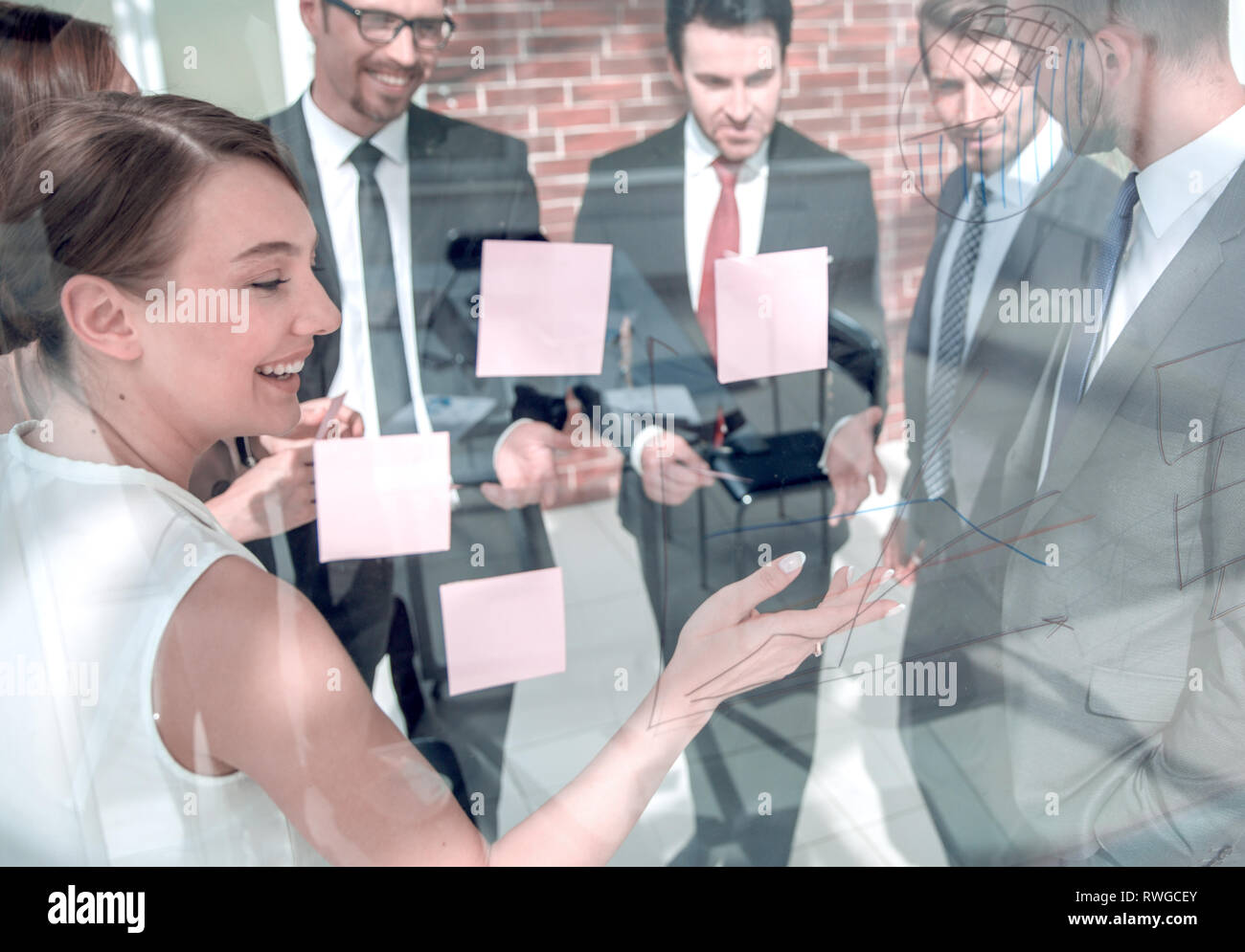 Manager shows business team business notes Stock Photo - Alamy