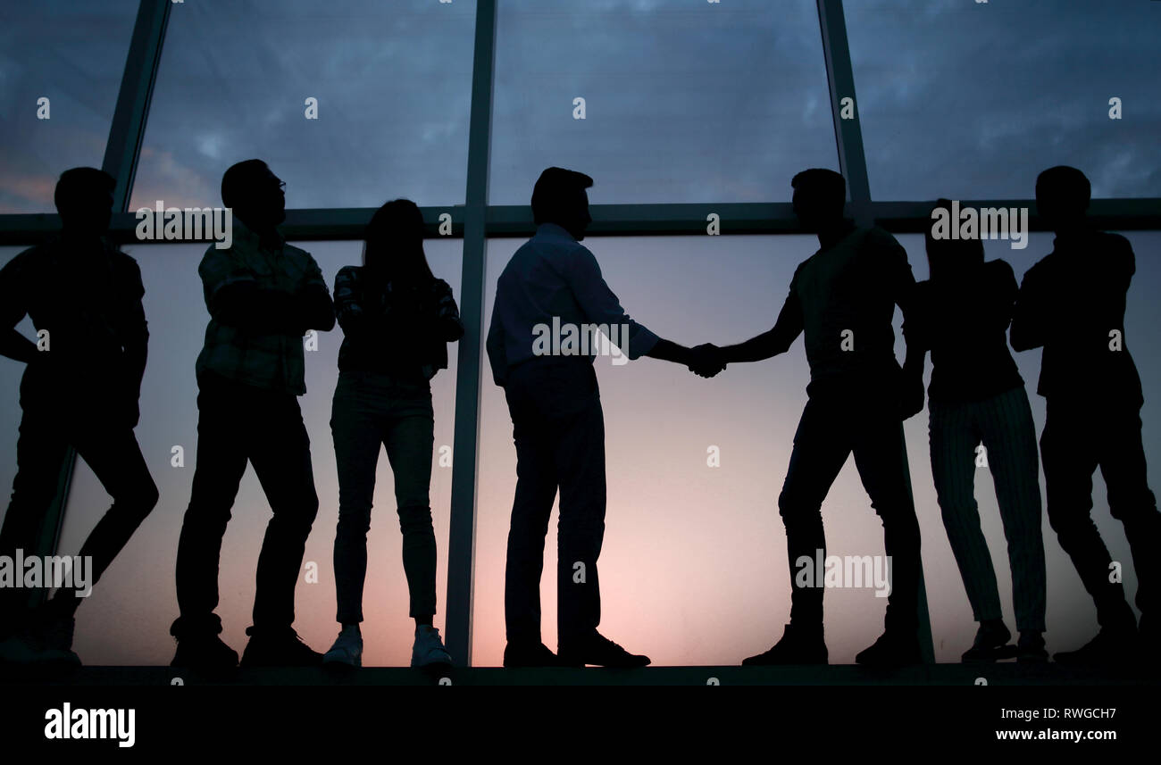 handshake of business partners on the background of the office window Stock Photo - Alamy