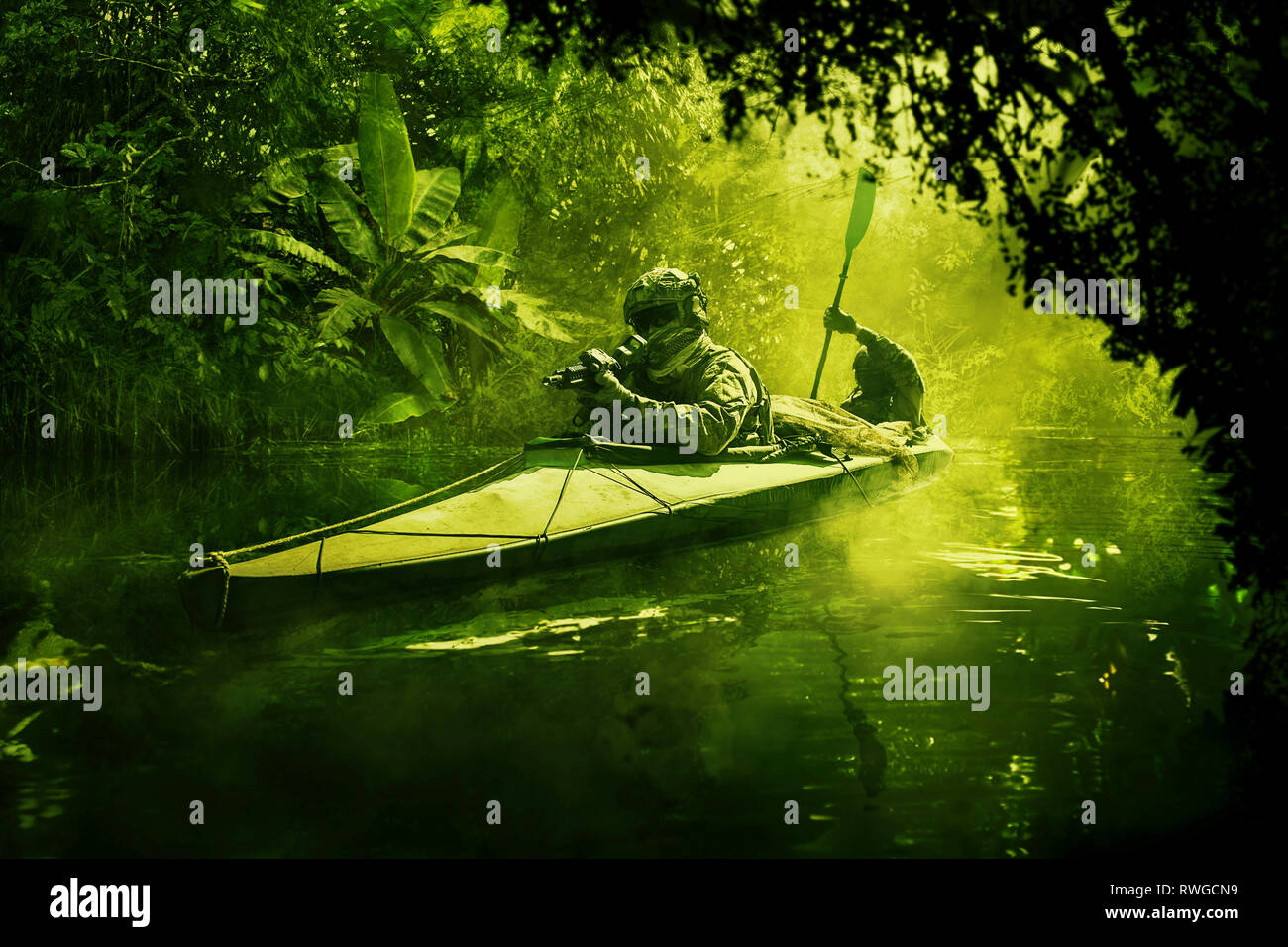 Two special forces operators paddling in a military kayak in the jungle ...